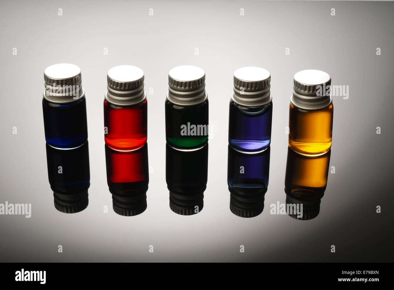 Five Colorful vials isolated on black background Stock Photo - Alamy