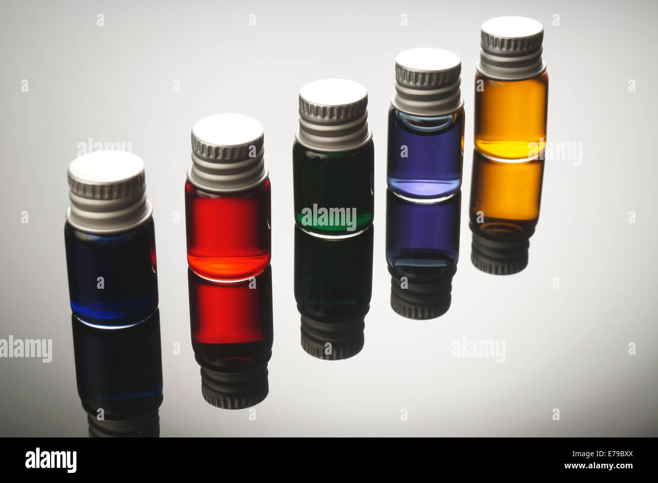 Five Colorful vials isolated on black background Stock Photo - Alamy