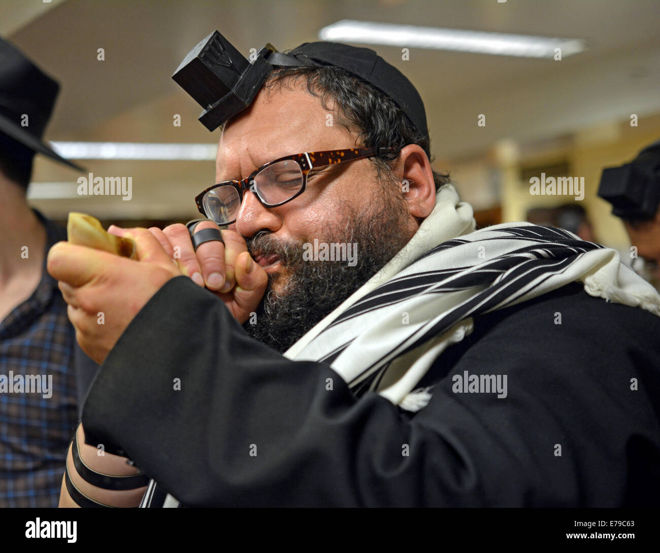 Religious Jewish man blows a small shofar during services prior to New ...