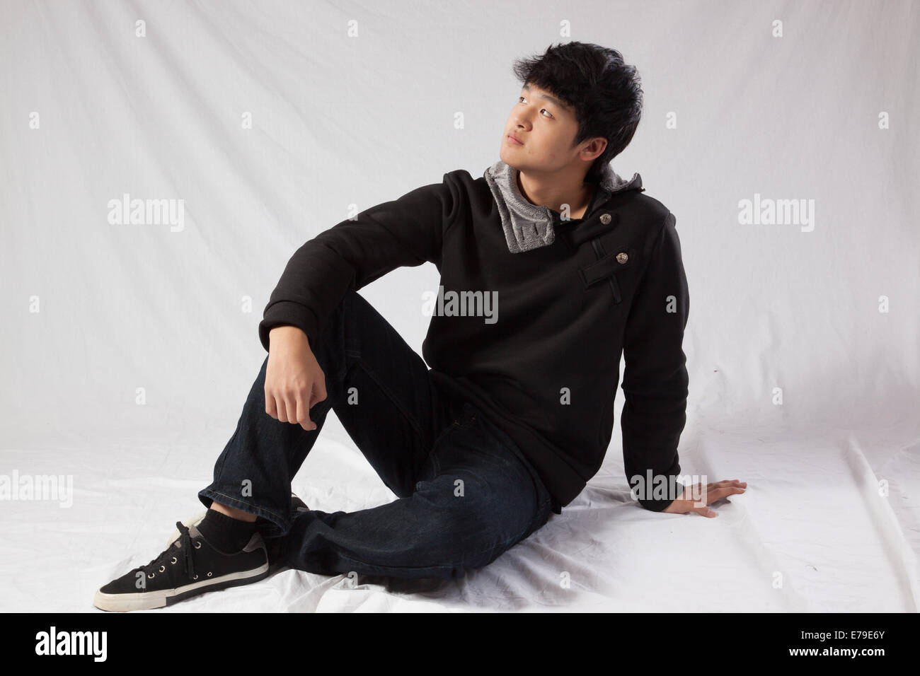 Handsome man sitting floor hi-res stock photography and images - Alamy