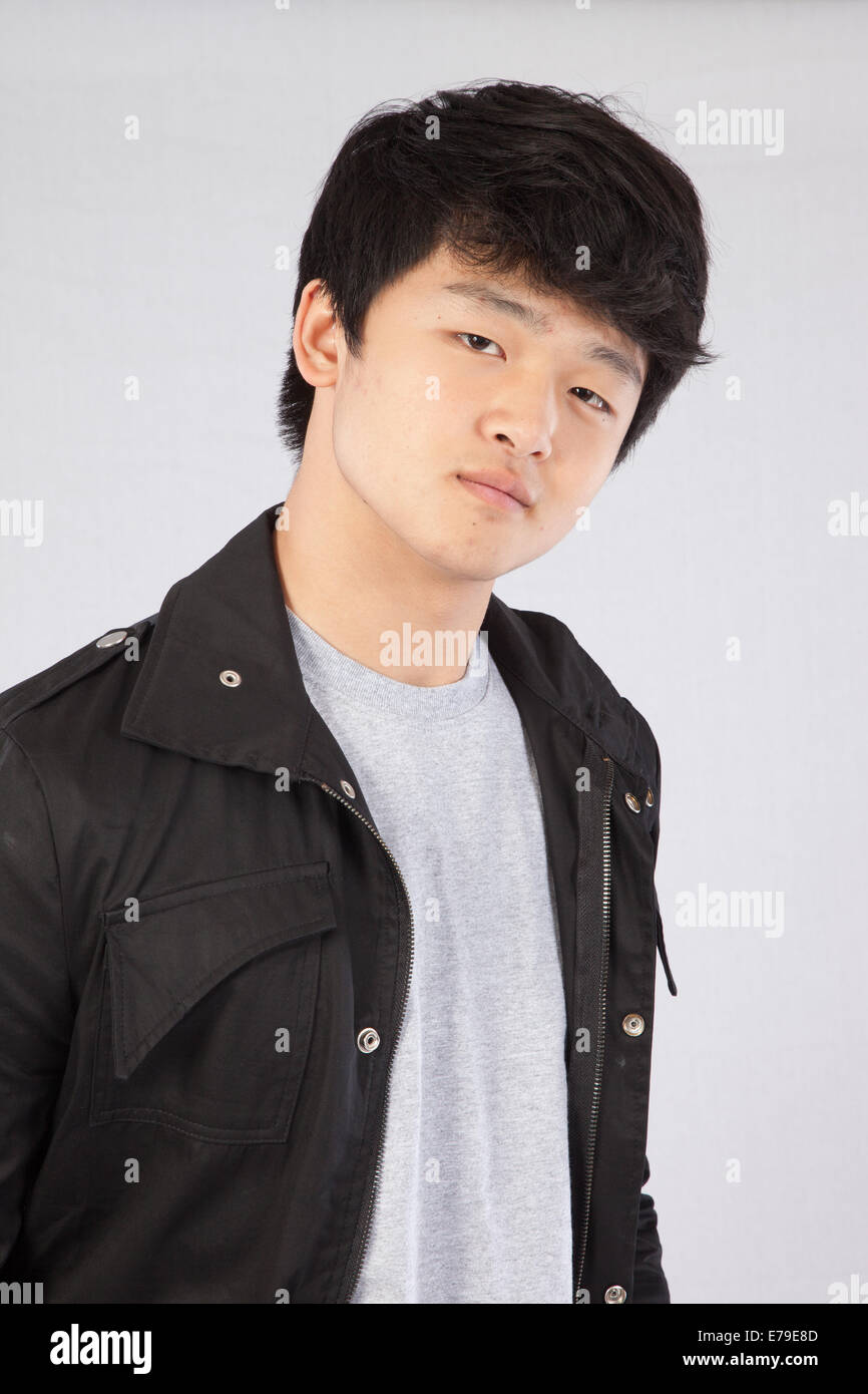 Handsome Asian man in a jacket and looking thoughtful Stock Photo - Alamy