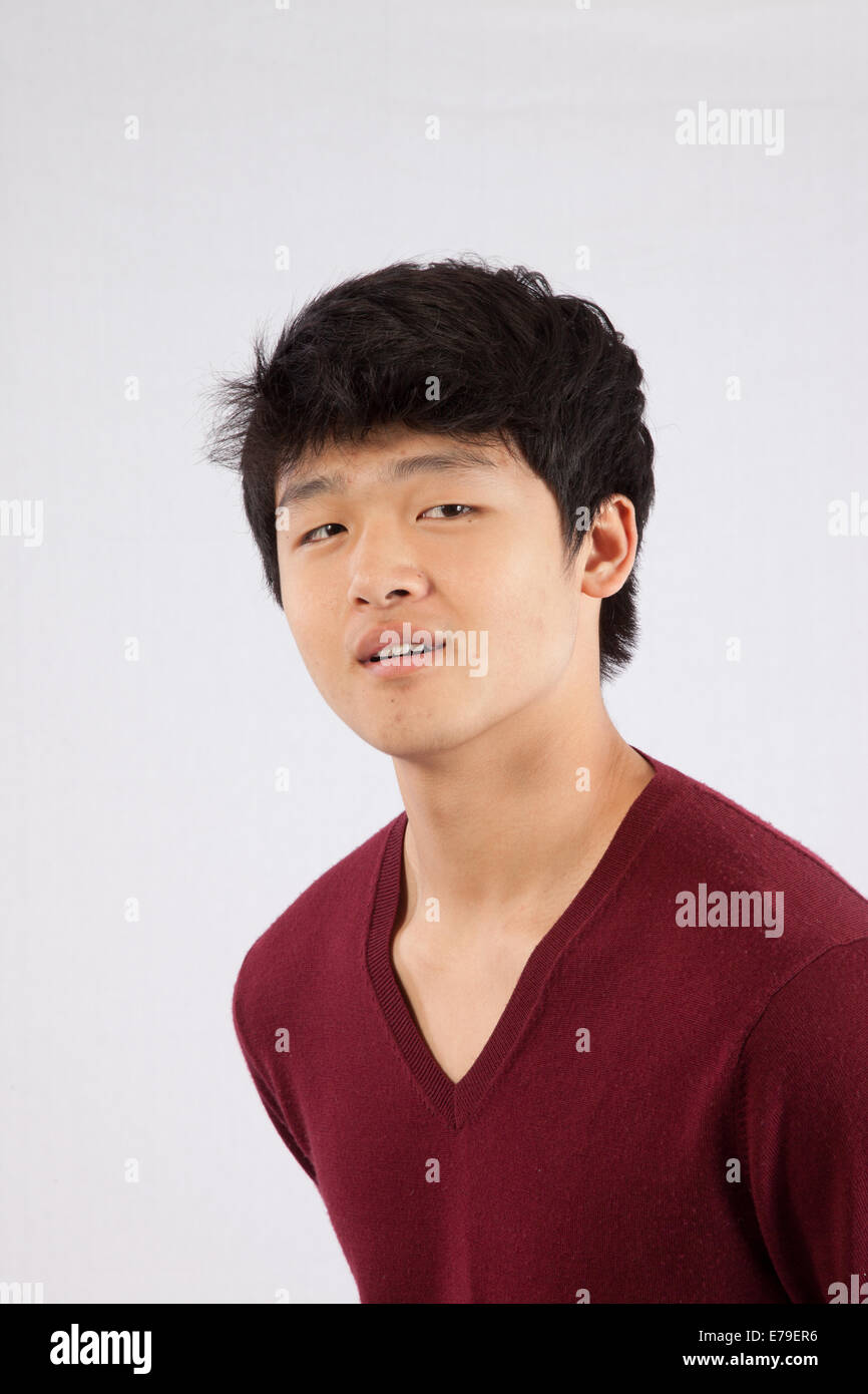 Asian man looking thoughtful Stock Photo - Alamy