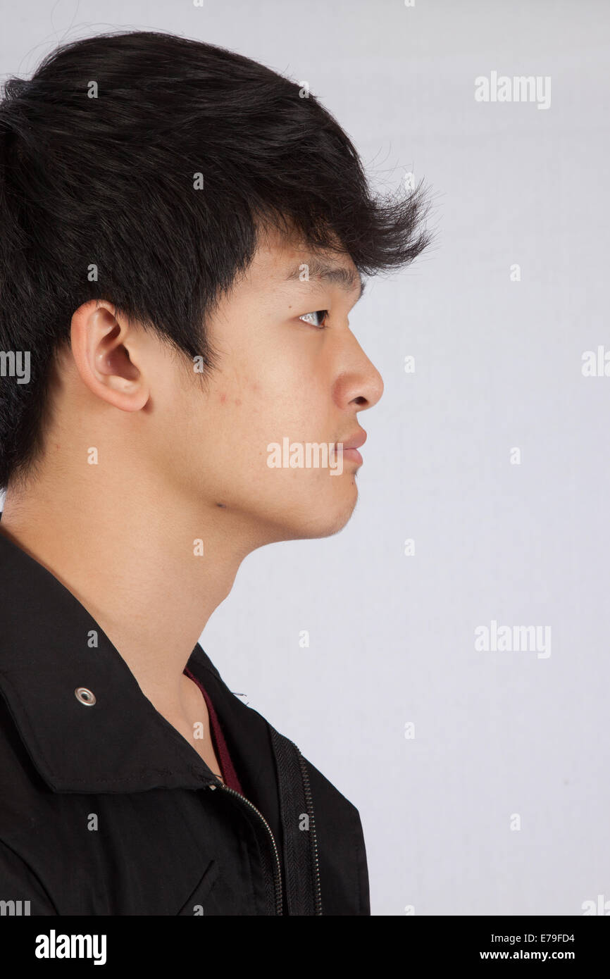 Handsome East Asian man looking thoughtful Stock Photo - Alamy