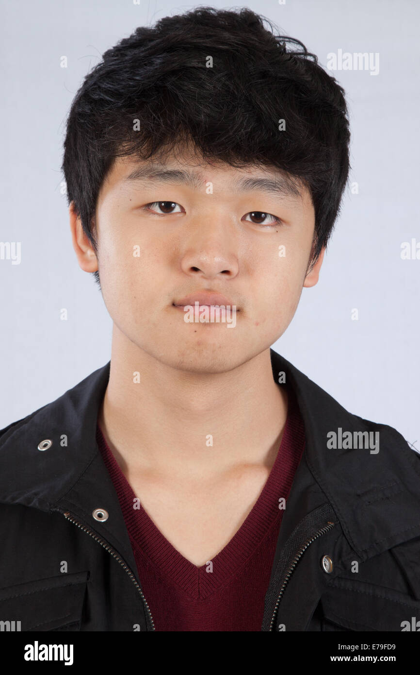 Handsome East Asian man looking thoughtfully at the camera Stock Photo ...