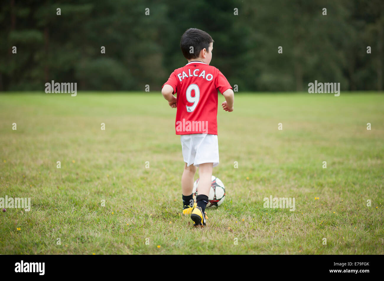 Kids playing football in football kit hi-res stock photography and ...