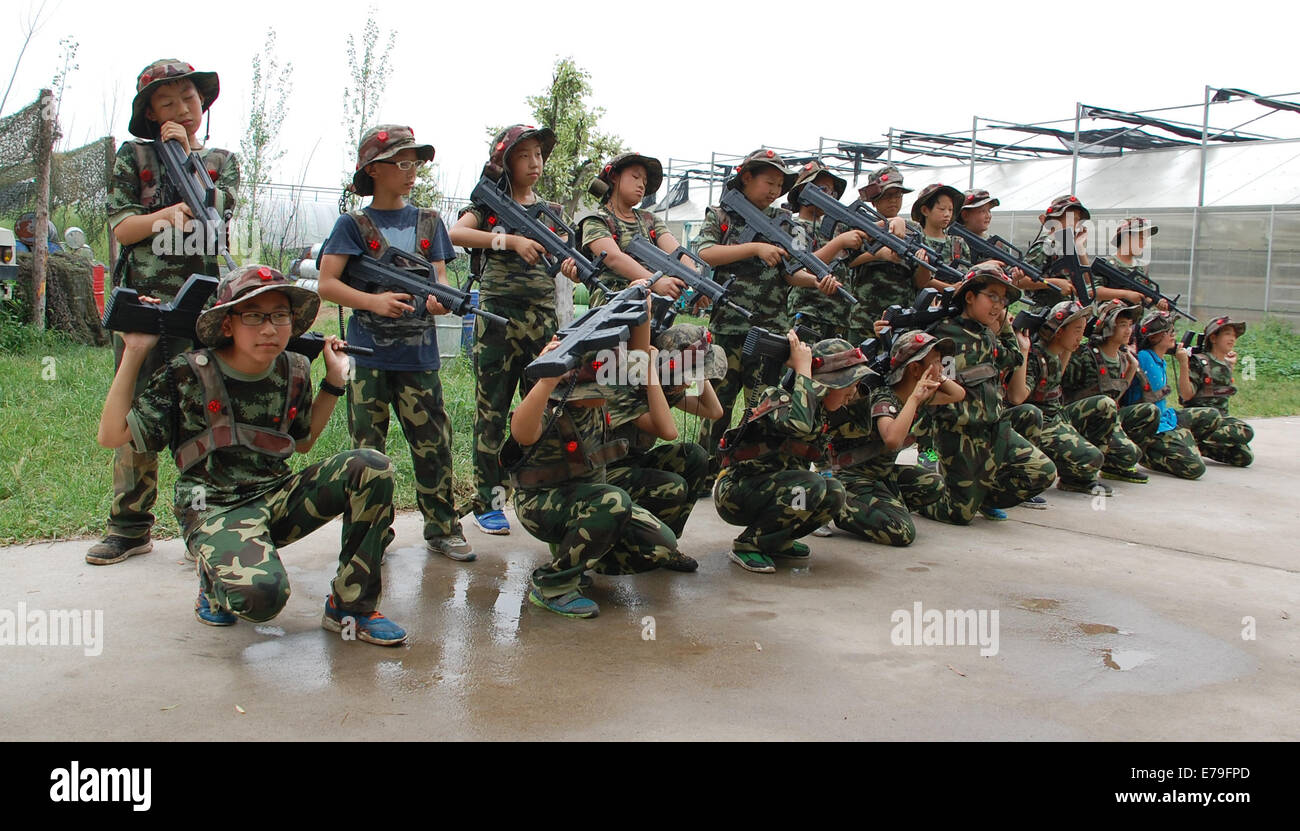 School students conduct excercises with dummy rifles at a military ...