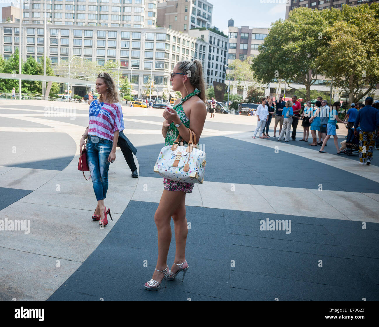 Fashionistas arrive and pose creating a fashion scene outside of the ...