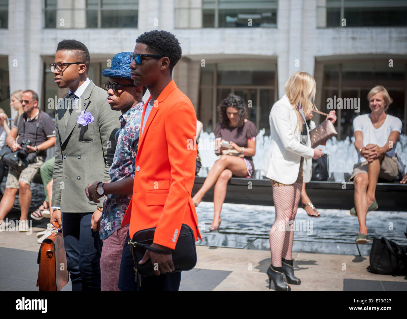 Fashionistas arrive and pose creating a fashion scene outside of the ...