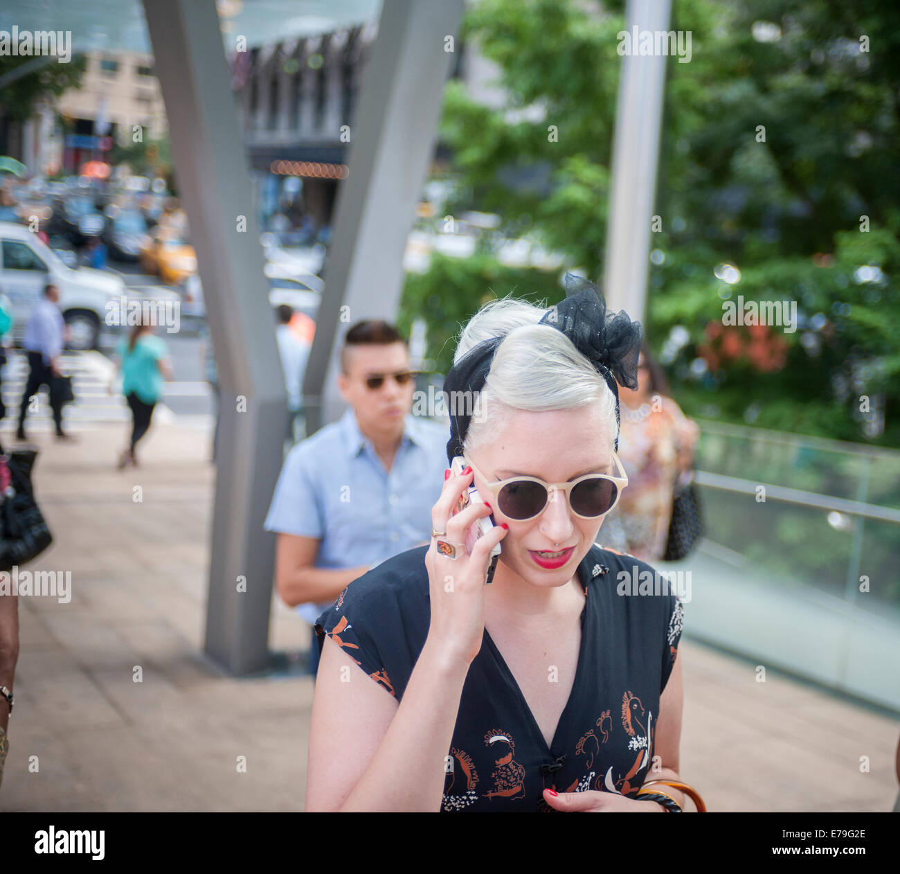 Fashionistas arrive and pose creating a fashion scene outside of the ...