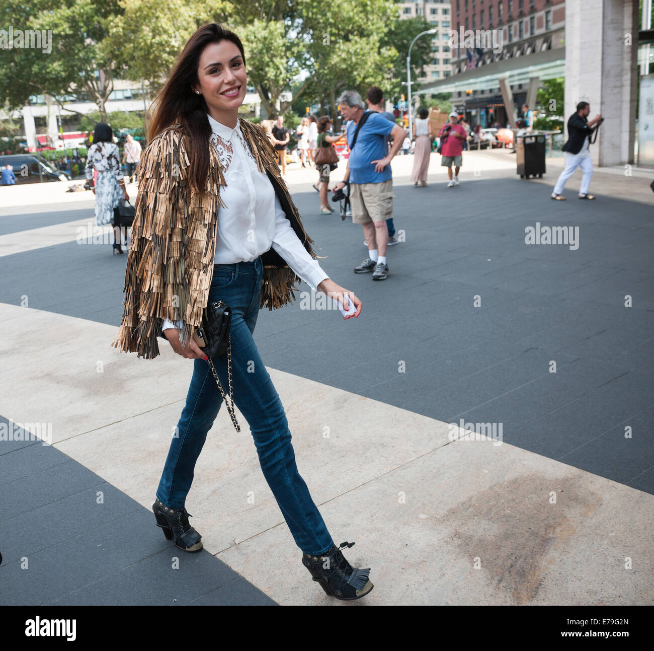 Fashionistas arrive and pose creating a fashion scene outside of the ...