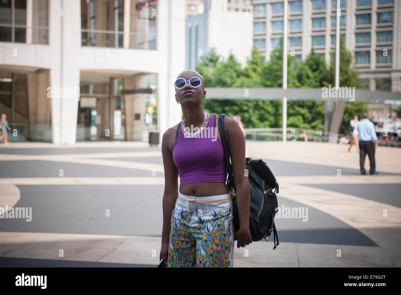 Fashionistas arrive and pose creating a fashion scene outside of the ...