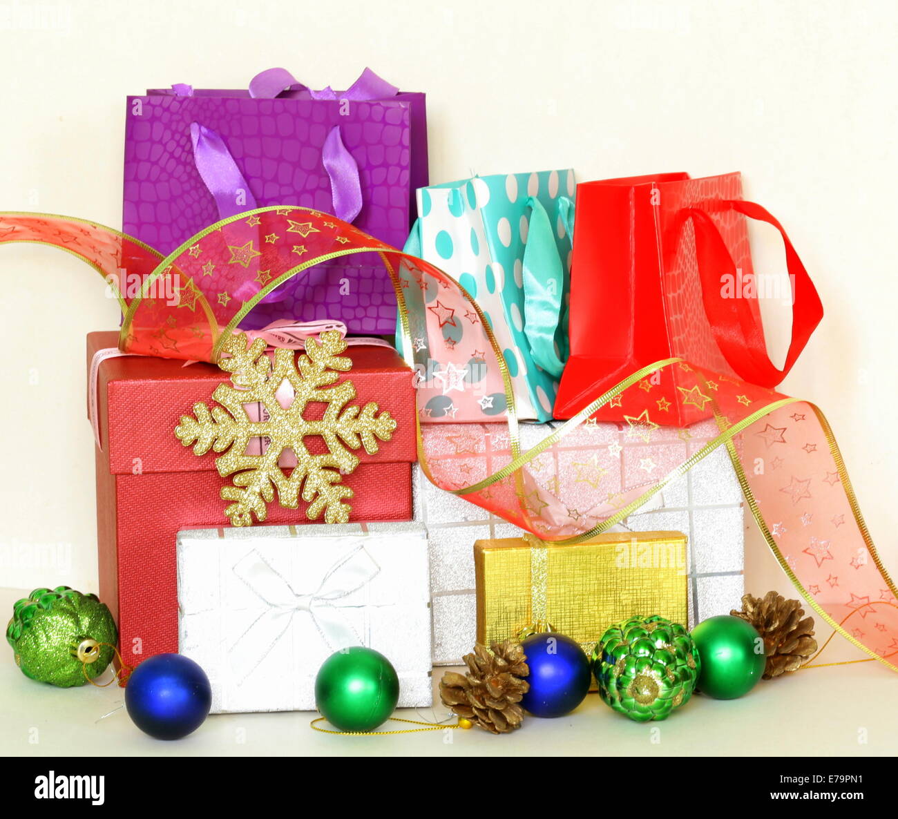 many gift boxes and colorful shopping bags with festive decorations ...