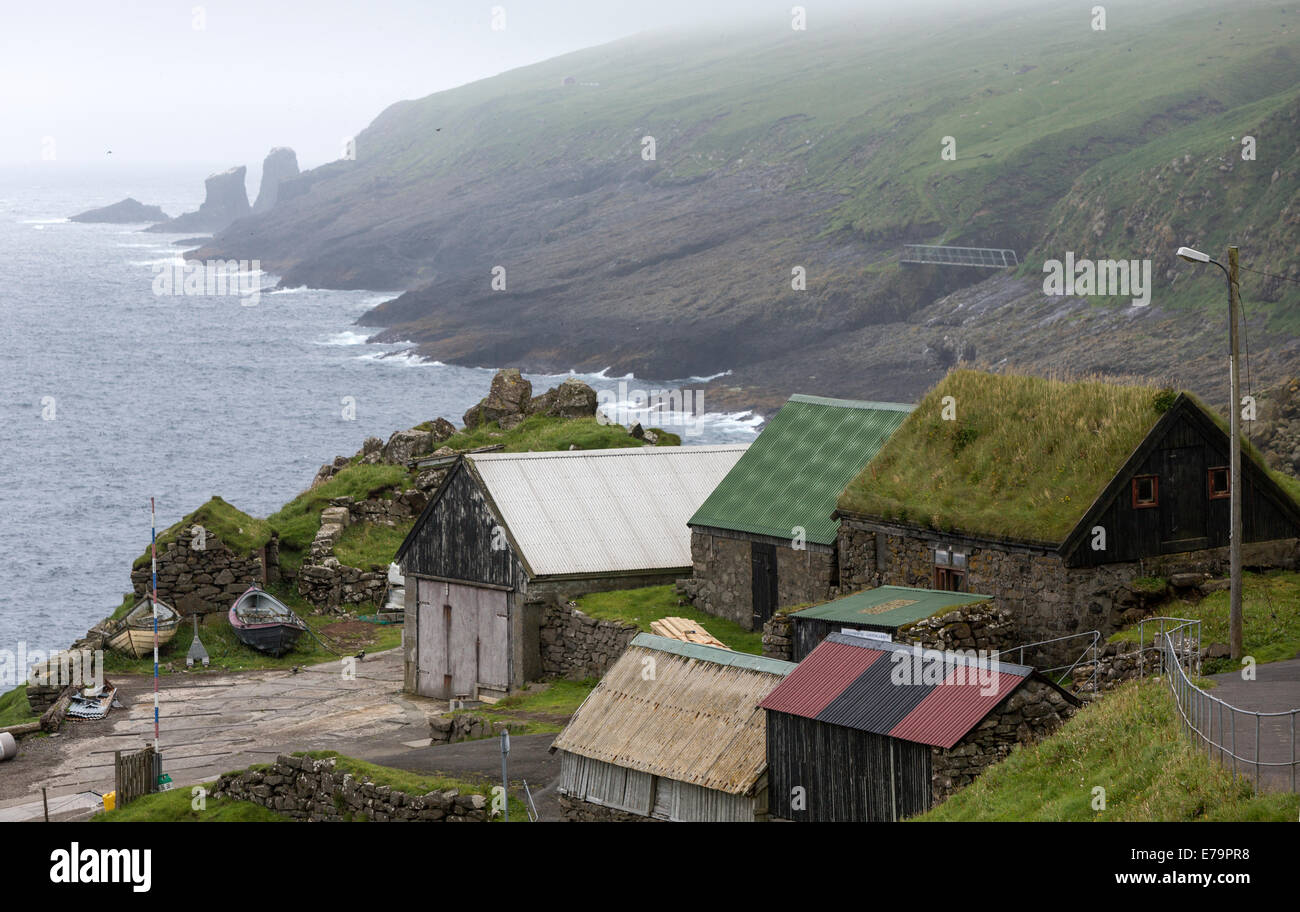 Mykines houses with grass turf covered for insulation near the jetty ...