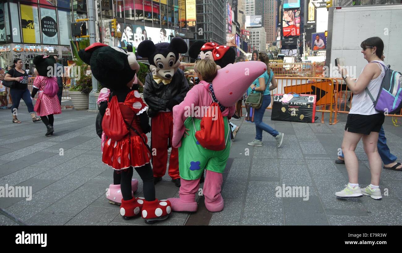 Actors in cartoon costumes wait for customers at Times Square in New ...