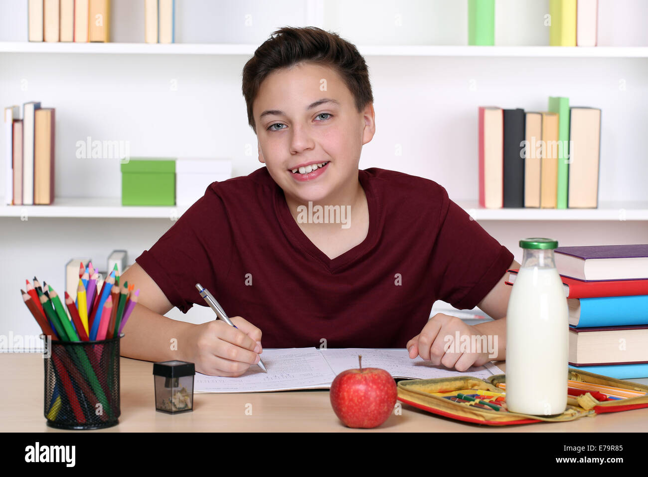 Young boy doing homework at school in his exercise book Stock Photo - Alamy