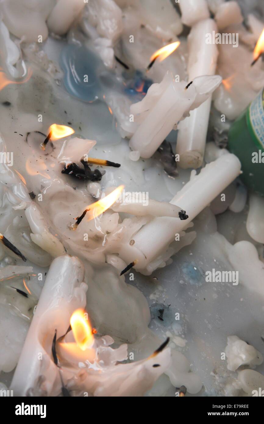 Candles melted together - Church candles melted together into a pool of ...
