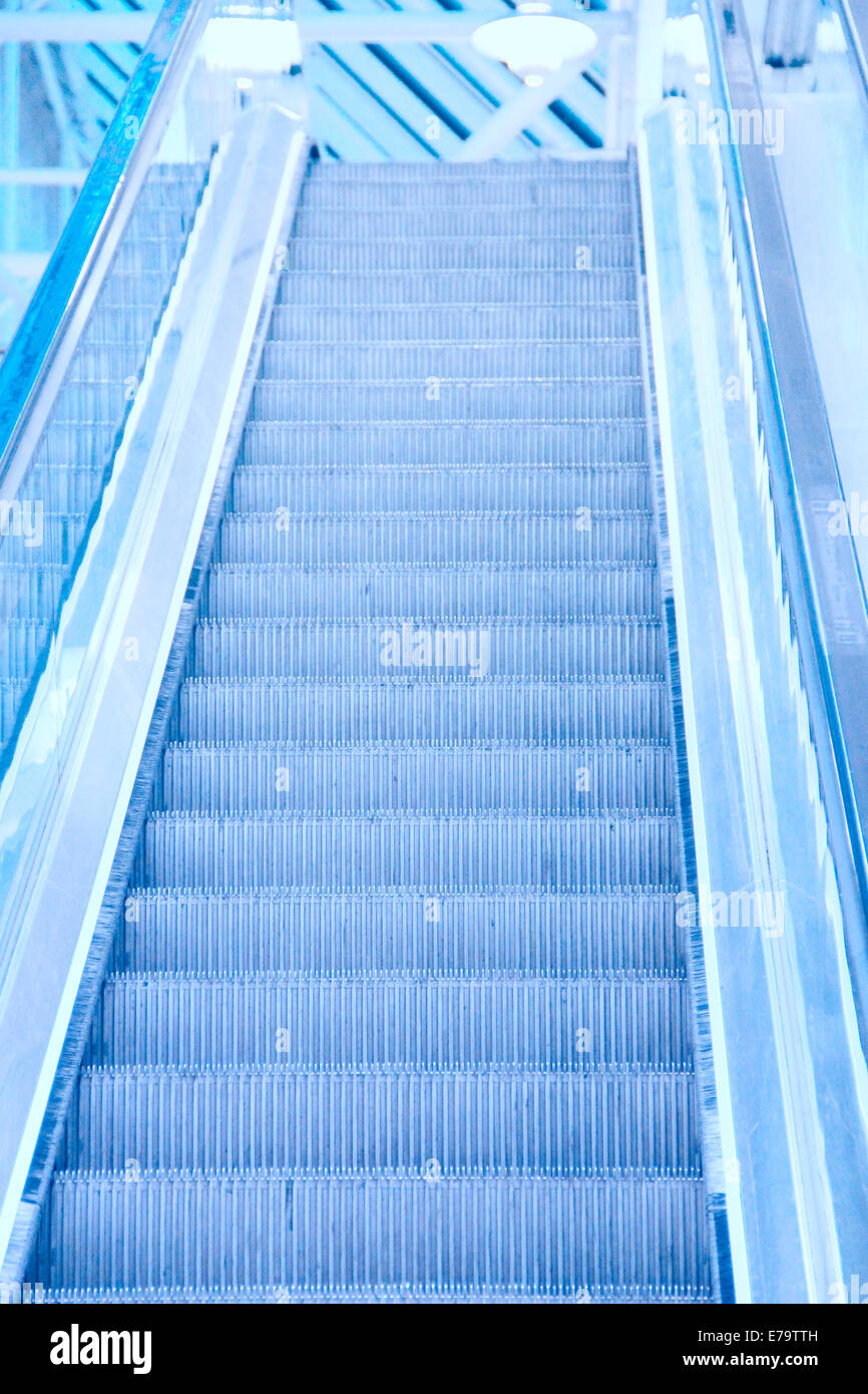 Perspective of escalator toned in blue color Stock Photo - Alamy