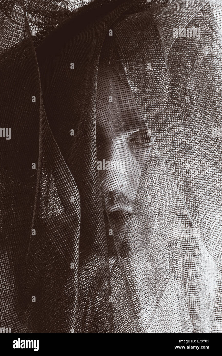 Studio portrait of a young man through the mesh Stock Photo - Alamy