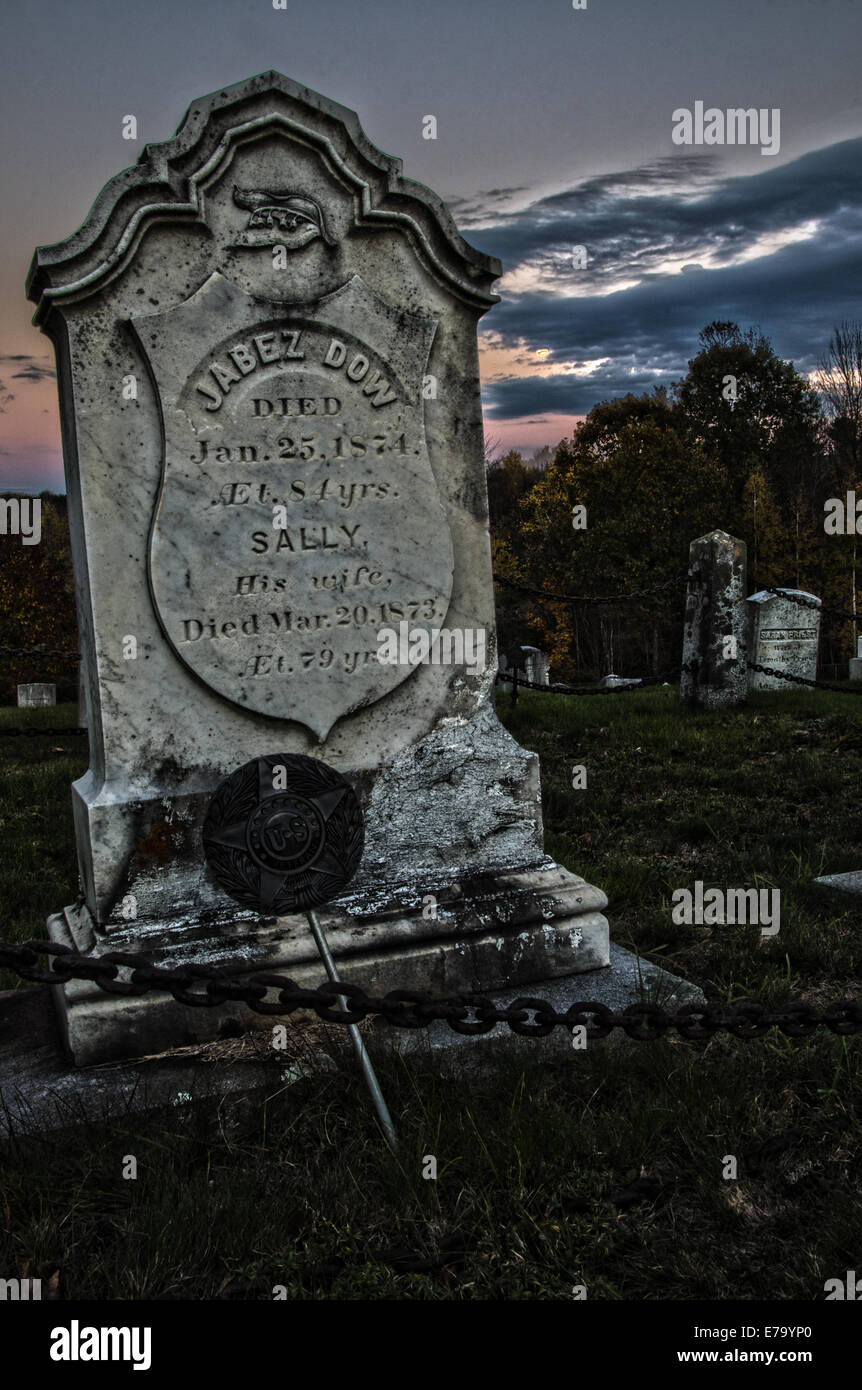 Headstone with setting sun Stock Photo - Alamy