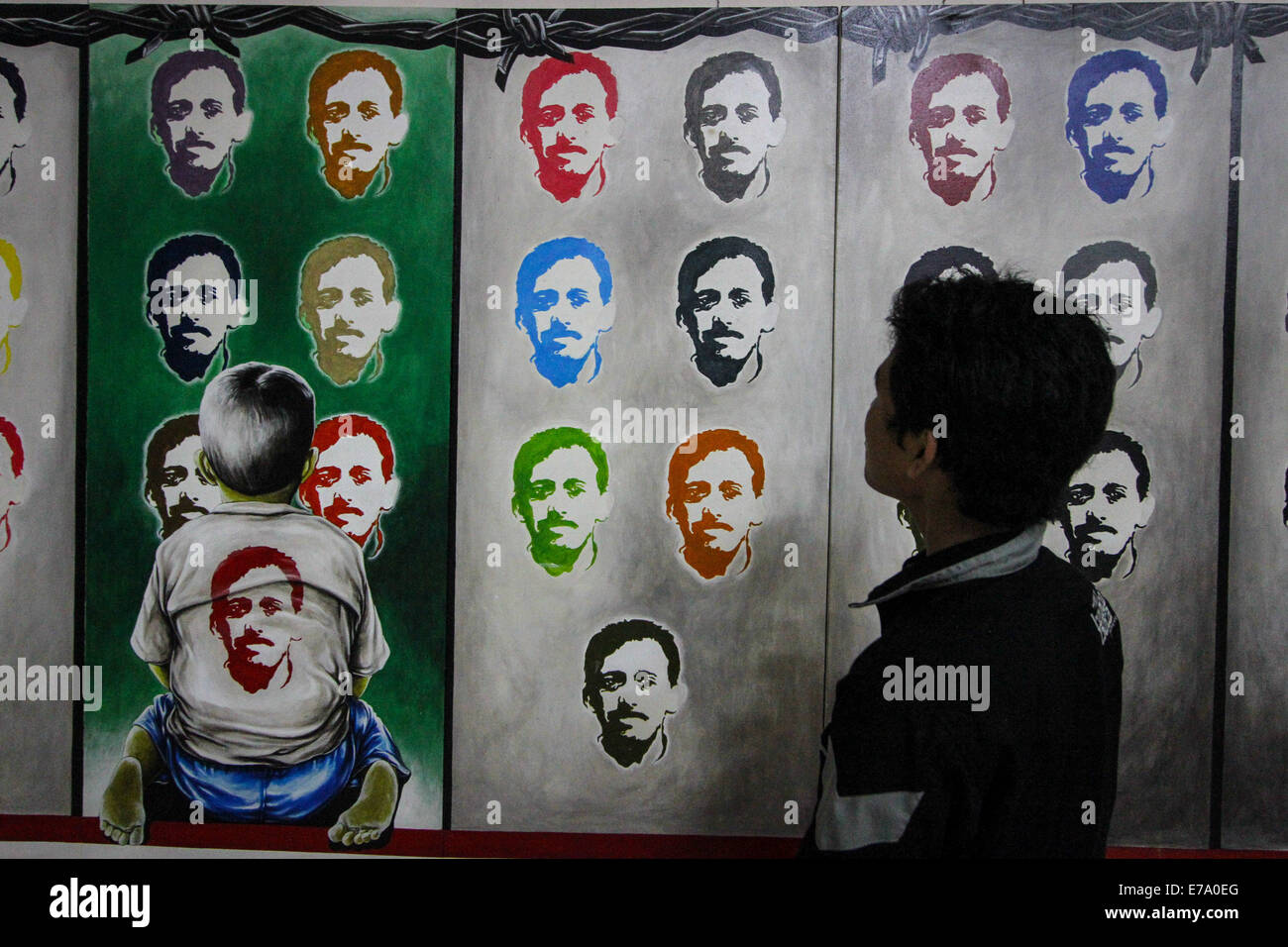 A visitor views paintings by Munir, an Indonesian artists, during an ...