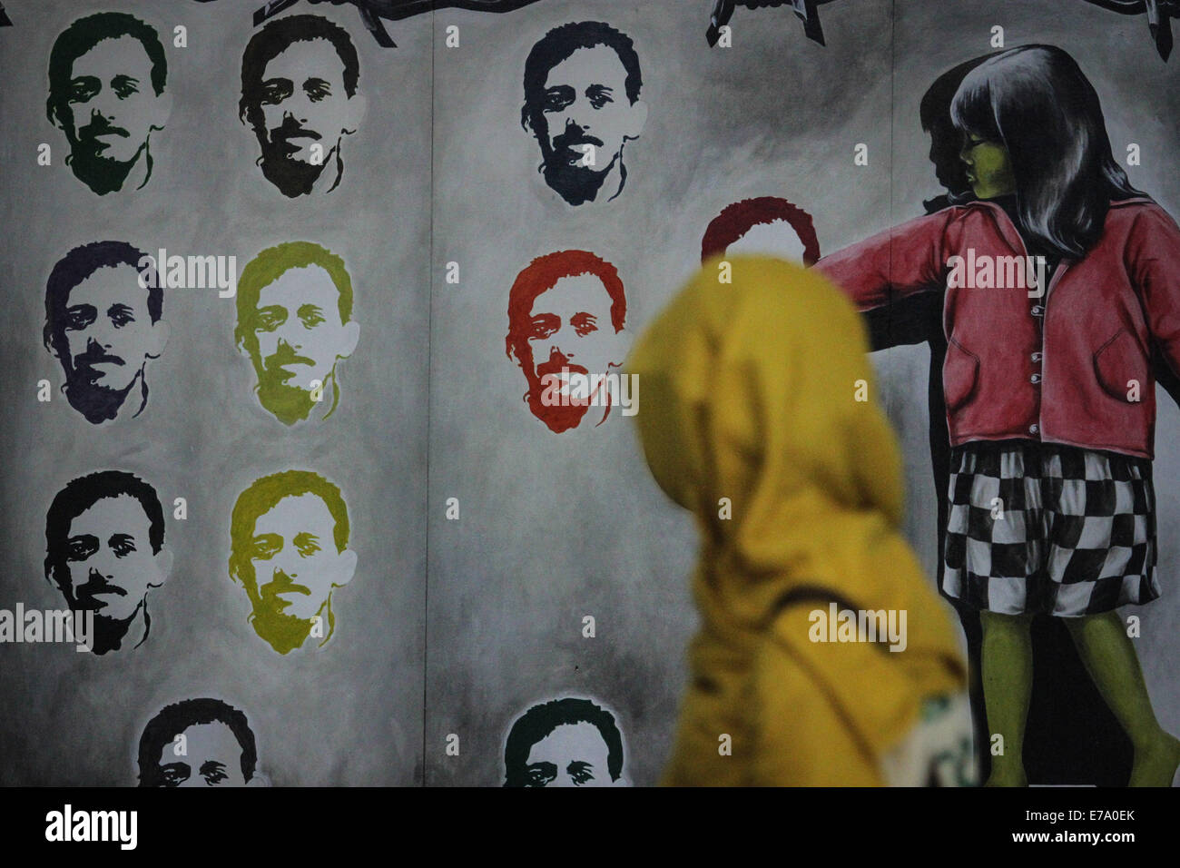A visitor views paintings by Munir, an Indonesian artists, during an ...