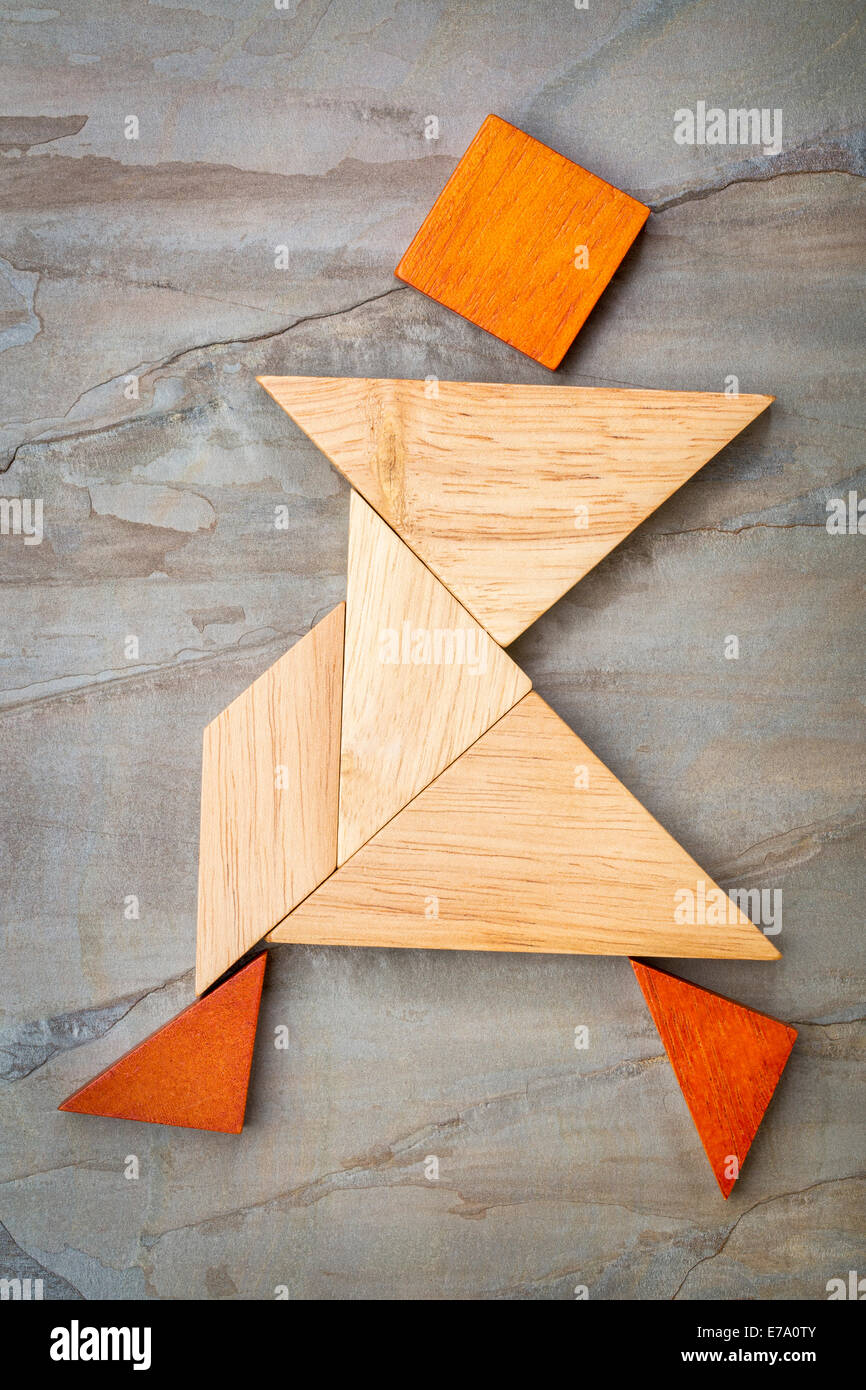 abstract of a dancing or walking figure built from seven tangram wooden ...