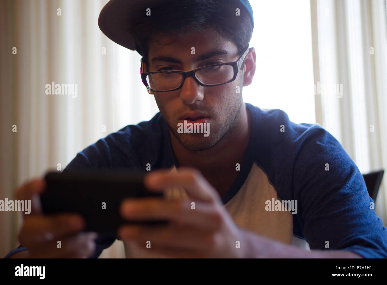 Man playing game on cell phone Stock Photo - Alamy
