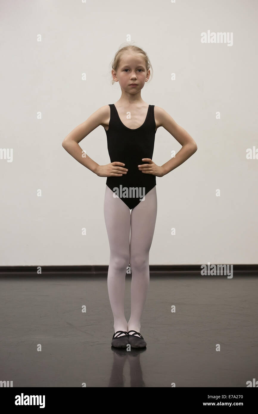 little girl training choreographic exercise, front full-length view ...