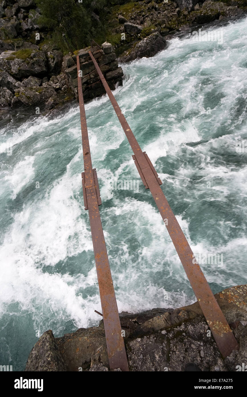 two rusty rails of damaged bridge over mountain tumultuous river Stock ...