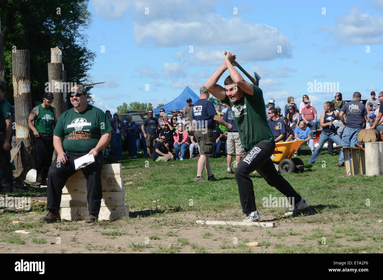 Lumberjack begins his ax throw at target log Stock Photo - Alamy