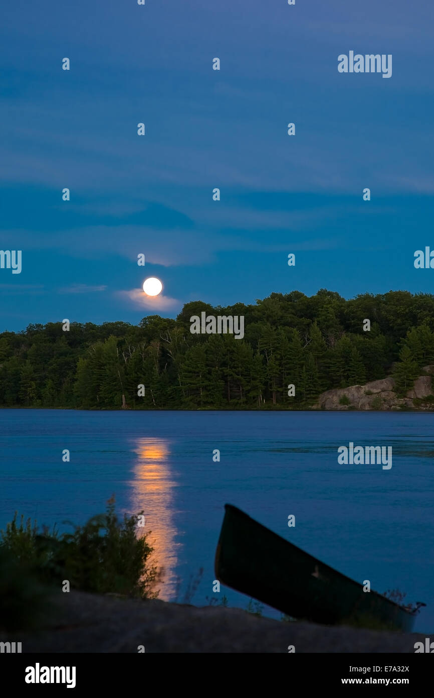 Moonlight over the river in the woods with canoe in front Stock Photo ...