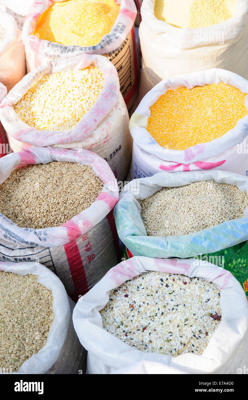 Bags of grains for sale in an outdoor market in rural China Stock Photo ...