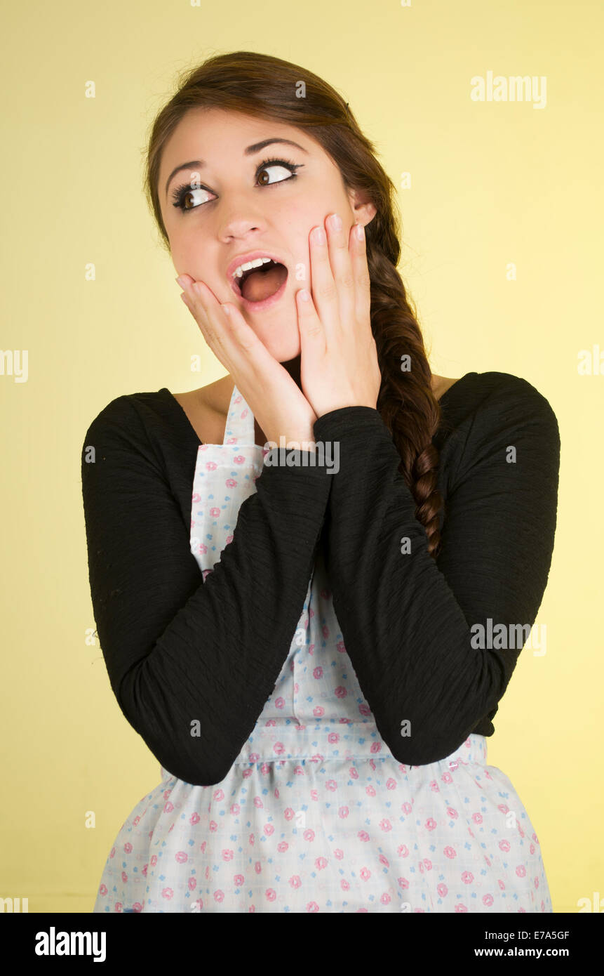 Happy pretty young girl wearing cooking apron Stock Photo - Alamy