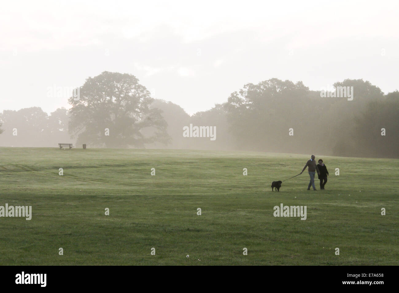 Oxford, UK. 11th September 2014. A couple walks their dog in south park ...