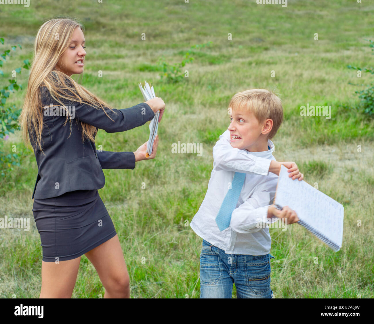 Pupils fight notebooks Stock Photo - Alamy