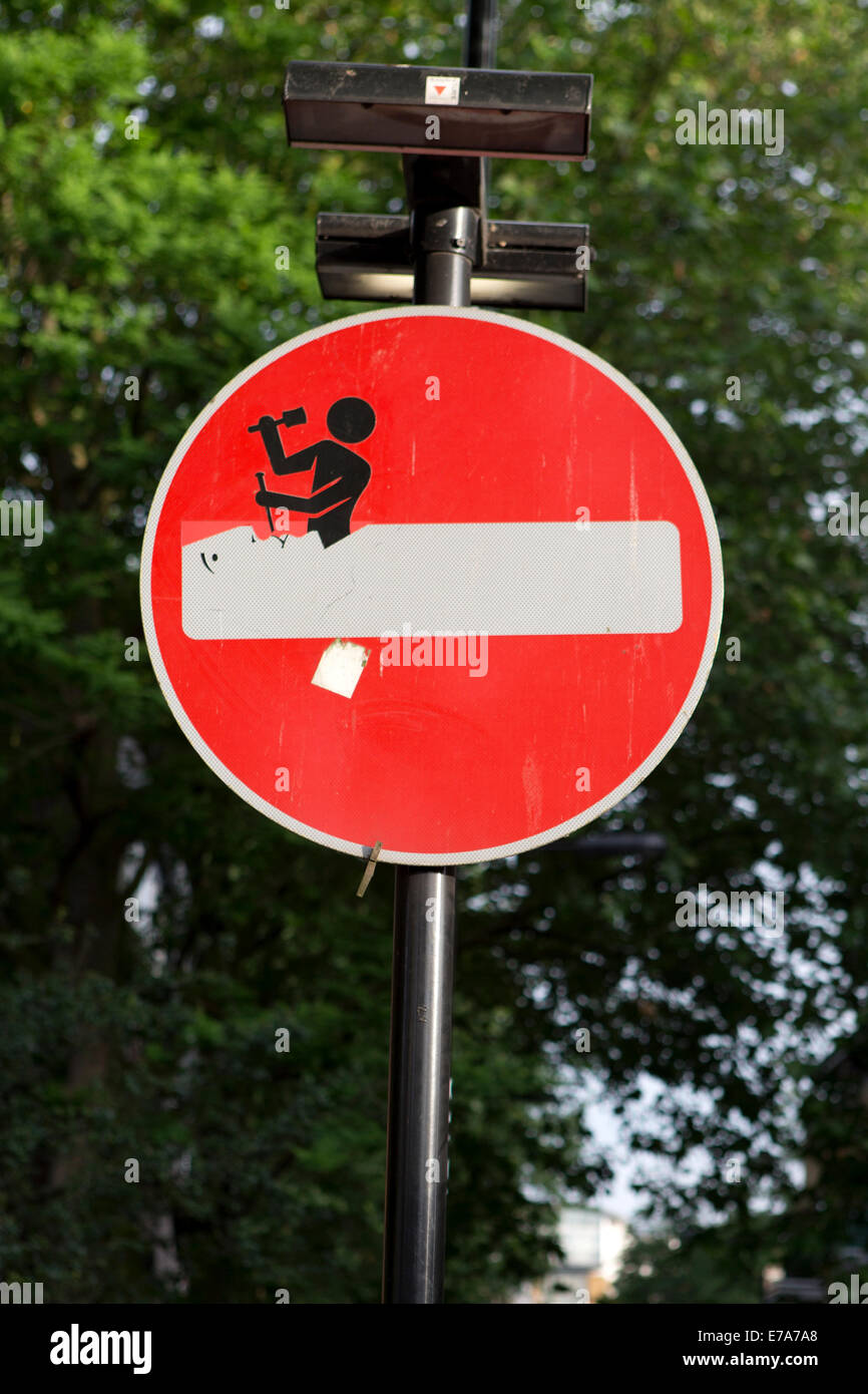 Graffiti on a No Entry street sign, Cartwright Street, London, England ...