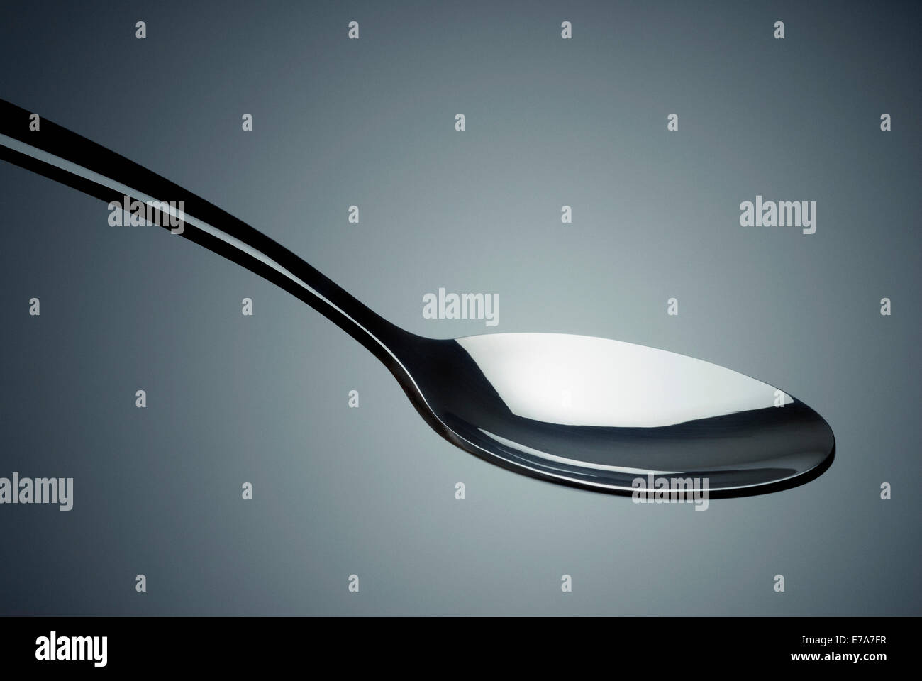 Close-up of a spoon in mid-air Stock Photo - Alamy