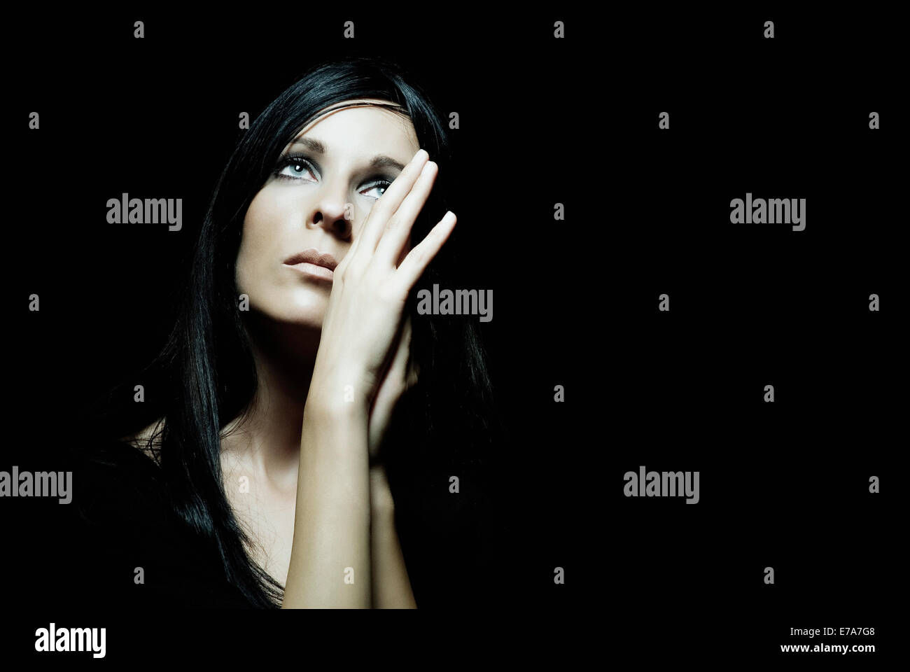 A beautiful woman staring up forlornly Stock Photo - Alamy