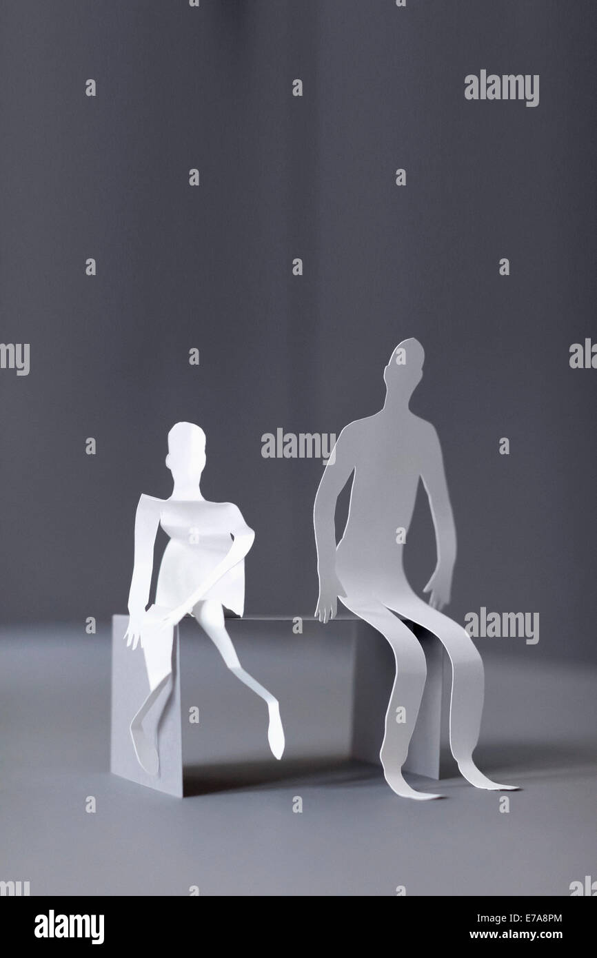 Tired and confident paper men sitting on bench over gray background ...