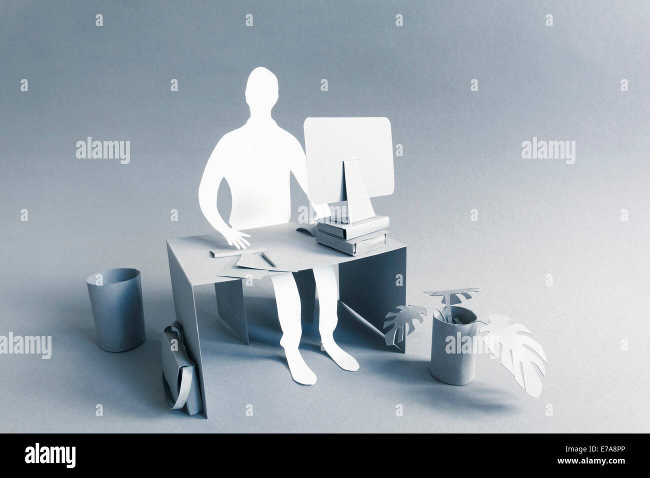 Paper businessman working at desk over gray background Stock Photo - Alamy
