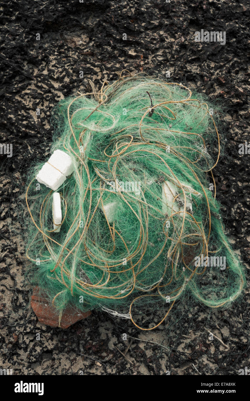 High angle view of fishing net on rock Stock Photo - Alamy
