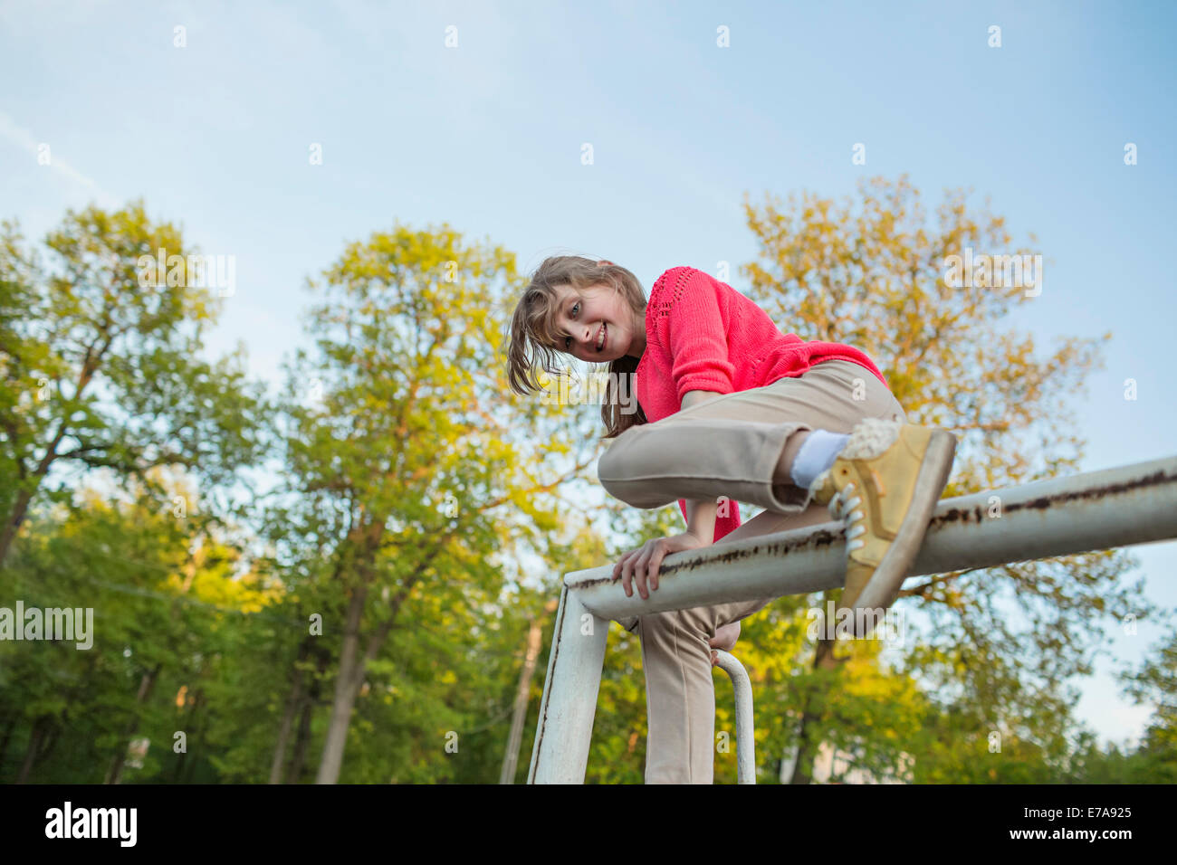 Portrait of girl climbing at playground Stock Photo - Alamy