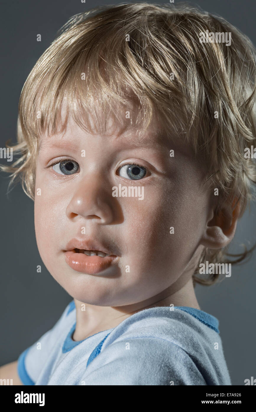 Portrait of cute boy over gray background Stock Photo - Alamy