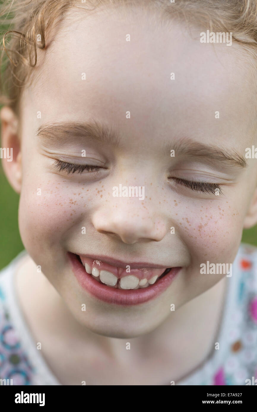 Close-up of cute girl smiling with eyes closed Stock Photo - Alamy