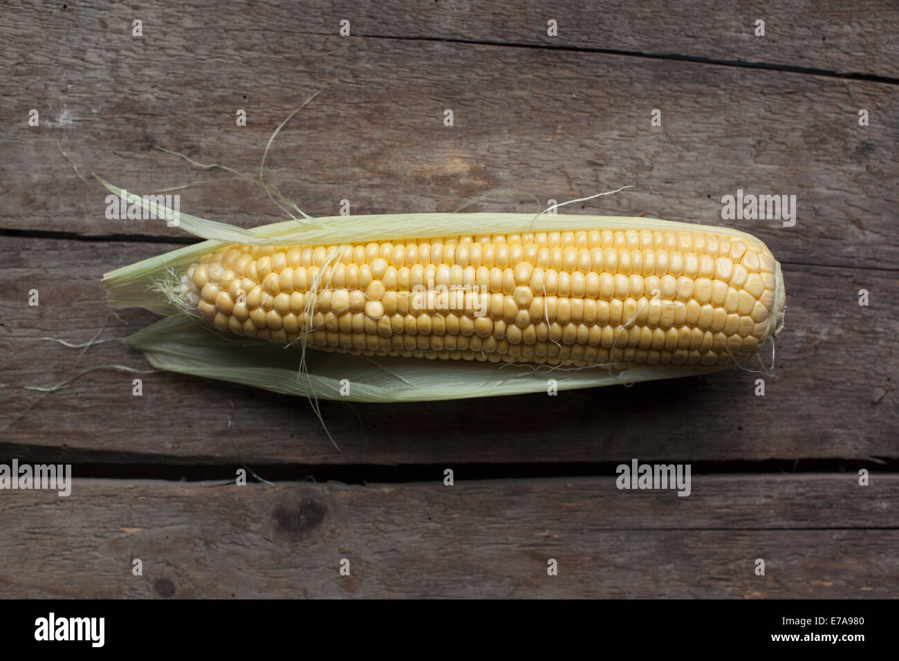 Corn cob on wooden table Stock Photo - Alamy