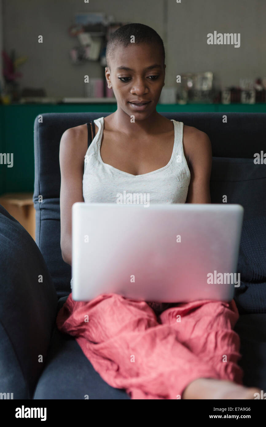 Using laptop sitting sofa at home hi-res stock photography and images ...