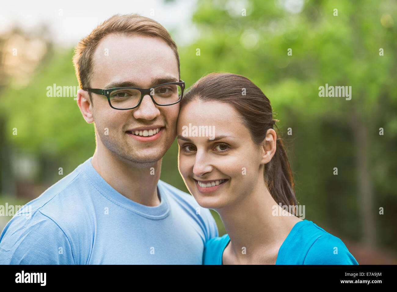 Portrait of young couple smiling together in park Stock Photo - Alamy