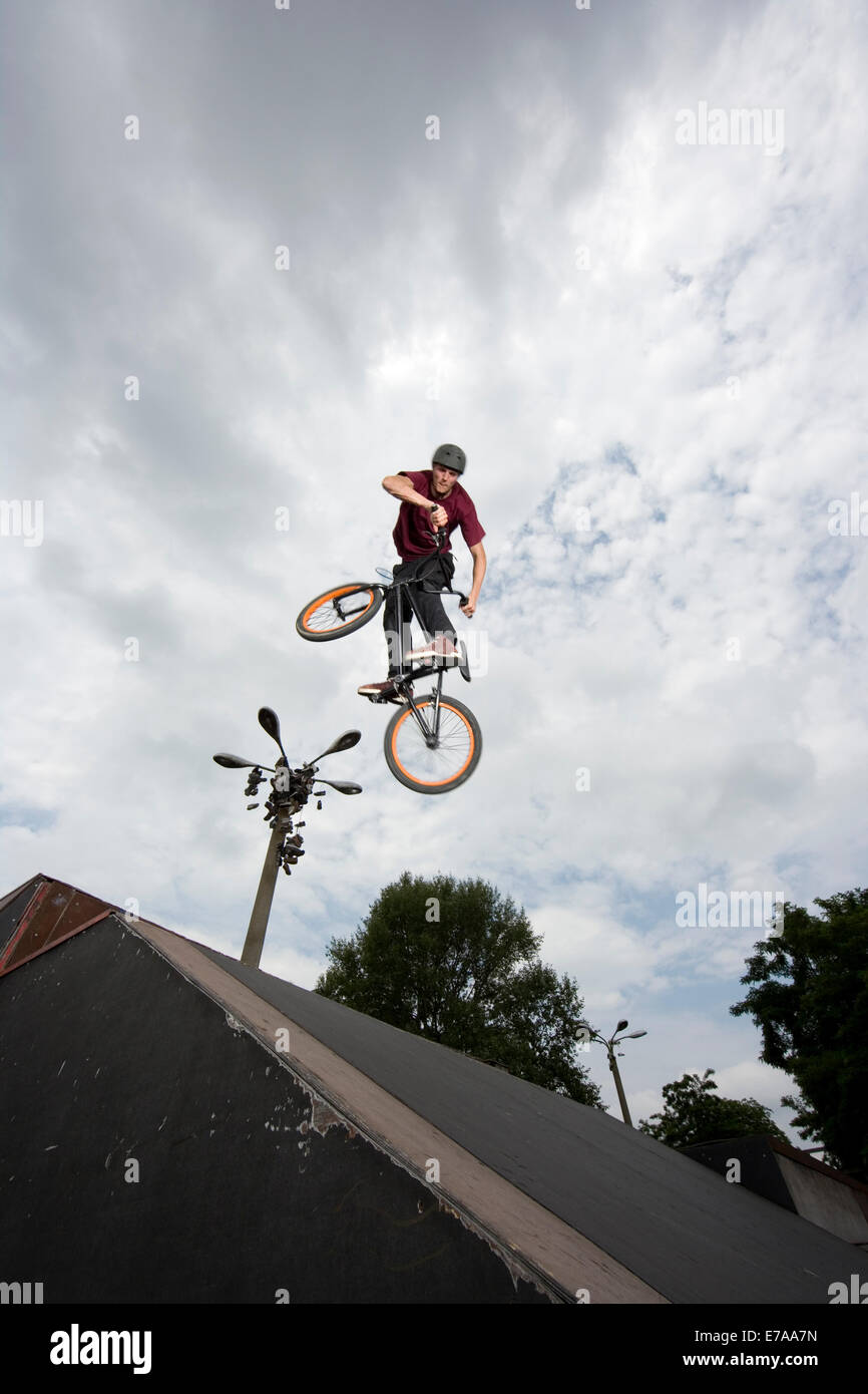 A young man in mid-air doing a stunt on a BMX bike Stock Photo - Alamy