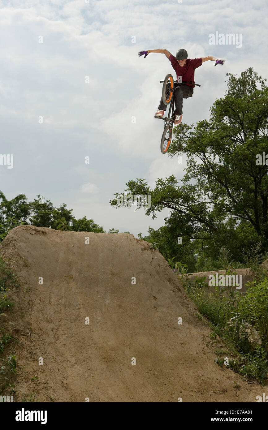 A BMX rider doing a stunt in mid air Stock Photo - Alamy
