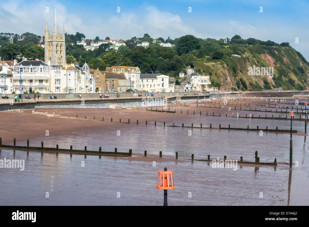 The sea front at Teignmouth, Devon. Groins stretch down the beach into ...